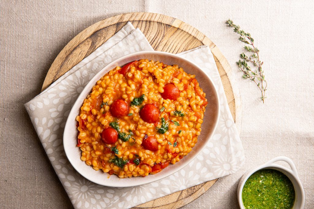 Pearl barley risotto with cherry tomatoes, light basil pesto, thyme and ...